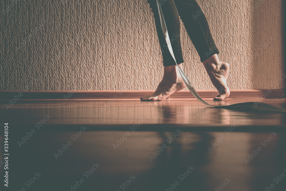 Girl dancing with a ribbon. Dancing at home. Female graceful bare feet ...