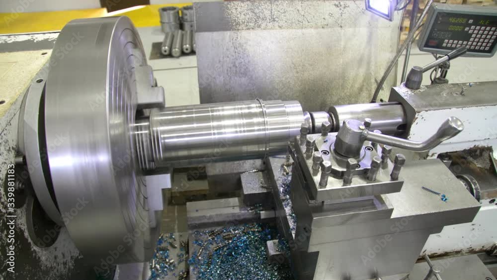 The lathe produces the metal part at the factory. Processing of the ...