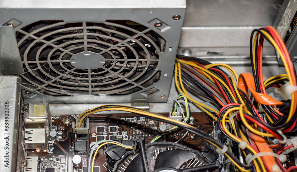 Computer power supply and motherboard close up. Colorful computer cable ...