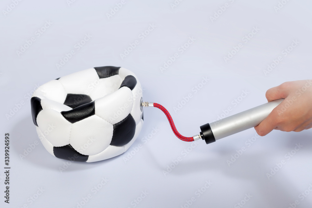 Hand pump and soccer ball on white background. Stock Photo | Adobe Stock