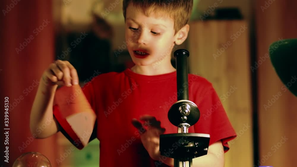 Little boy in science lab study samples under microscope. Schoolboy ...