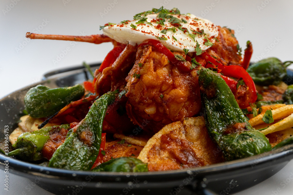 lobster cassolette, potatoes and fried eggs on a pan with white ...