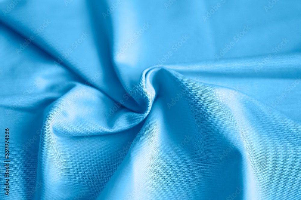microfiber fabric blue color background with pleats, top view. toned ...