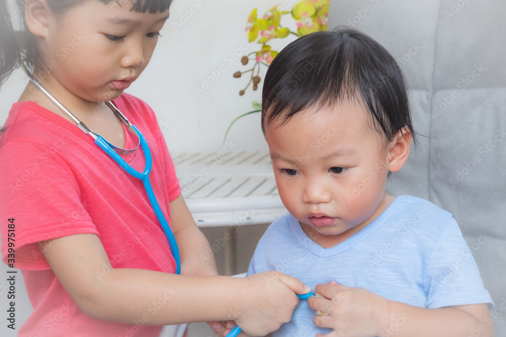 Little girl playing a doctor,boy and girl playing doctor and patient ...