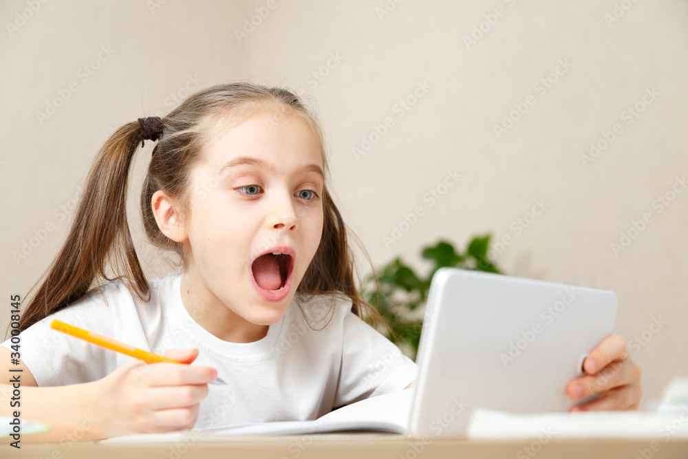 Distance learning online education. Schoolgirl studying at home with ...