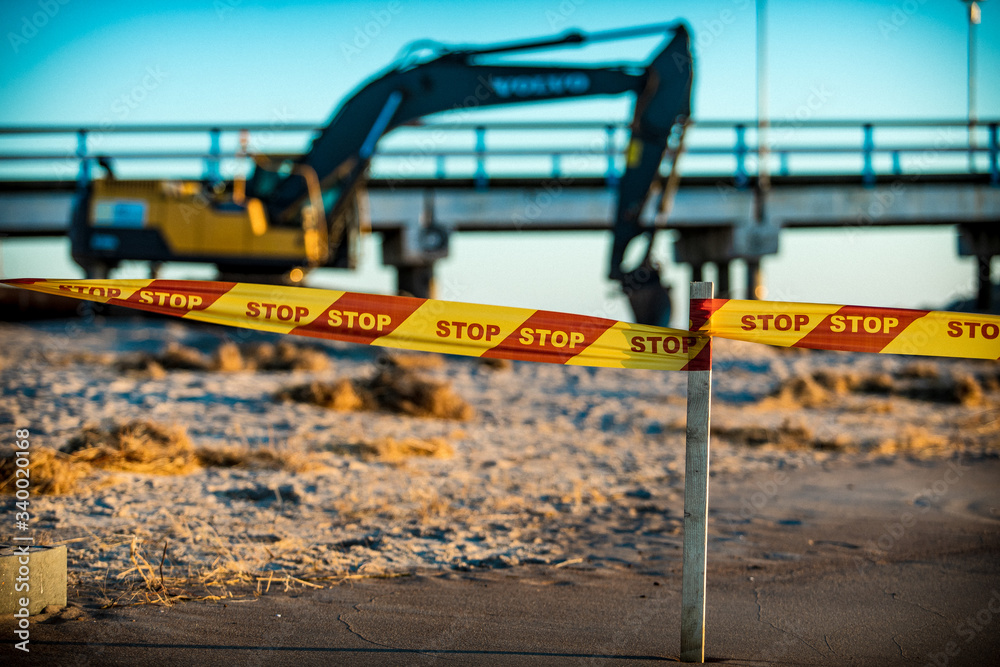 Poster Stop line on the beach excavator digging sand – Wall Art | UkPosters
