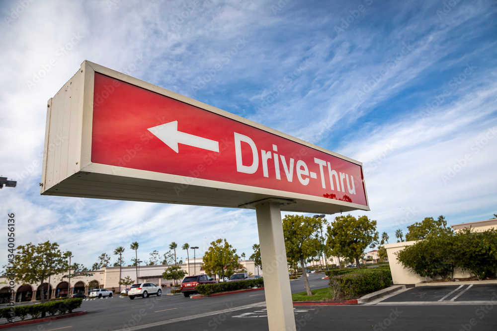 Red rectangular sign reading Drive Thru for fast food retaurant against ...