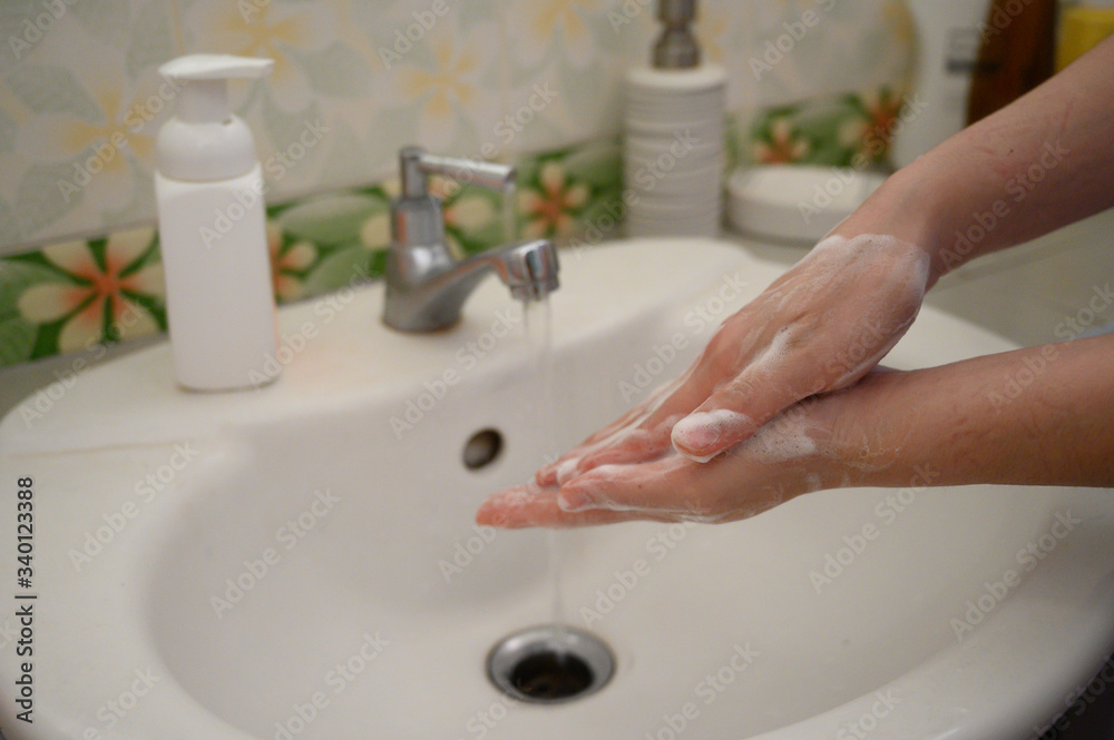Cropped shot view of woman washing hands at sink basin faucet in toilet ...