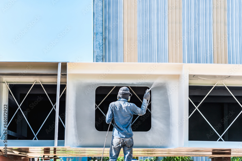 Airless Spray Painting, Worker painting on steel wall surface by ...