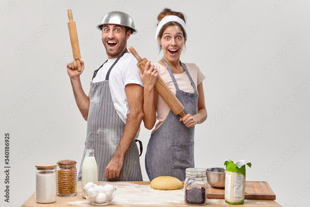 Excited happy professional woman and man chefs work in restaurant ...
