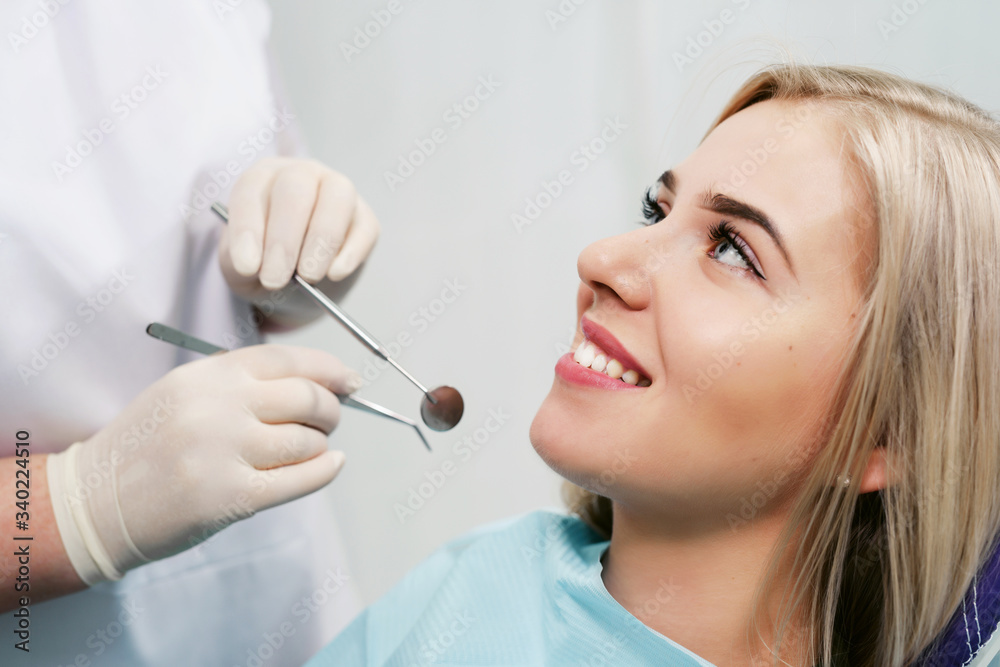 Dentist examining a patient's teeth in modern dentistry office. Closeup ...