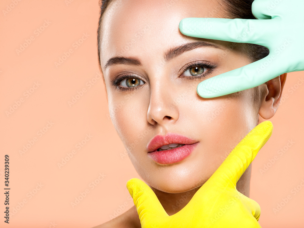 Face skin check before plastic surgery. Beautician touching young woman ...