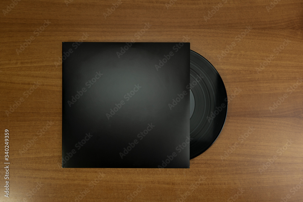 Empty Black Vinyl disk case with vinyl piece in a wood background for ...