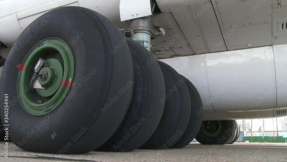 Close up worn tires of a passenger plane at the airfield. shot of the ...