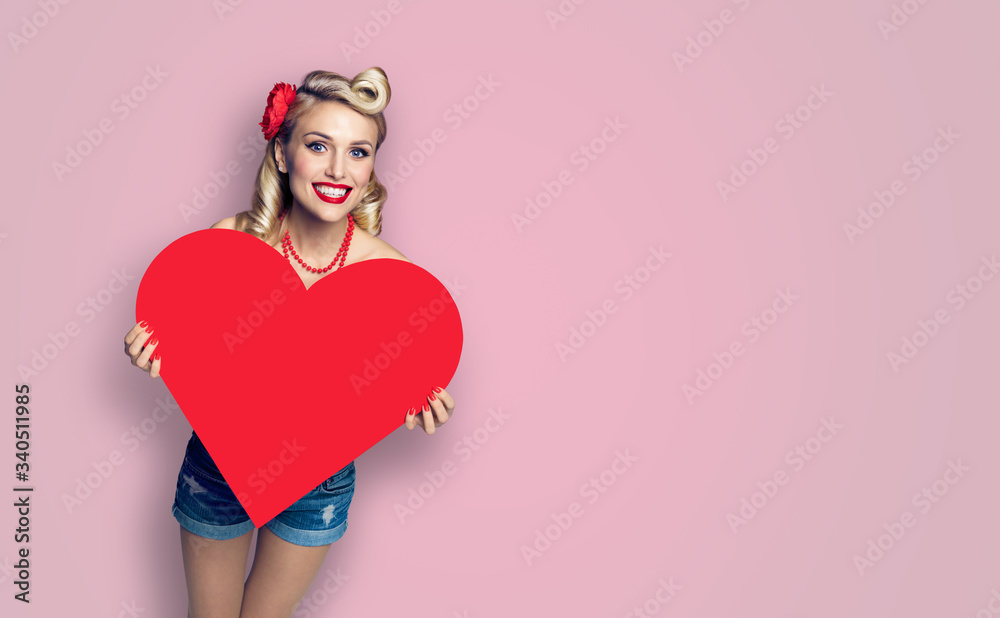 Woman holding red paper heart shape. Pin up lovely girl. Model at retro ...