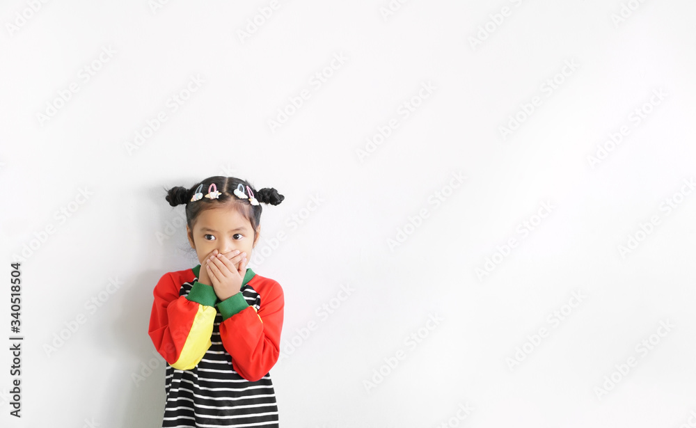 Asian child preschool or kid girl two hand close mouth for gag secrets ...
