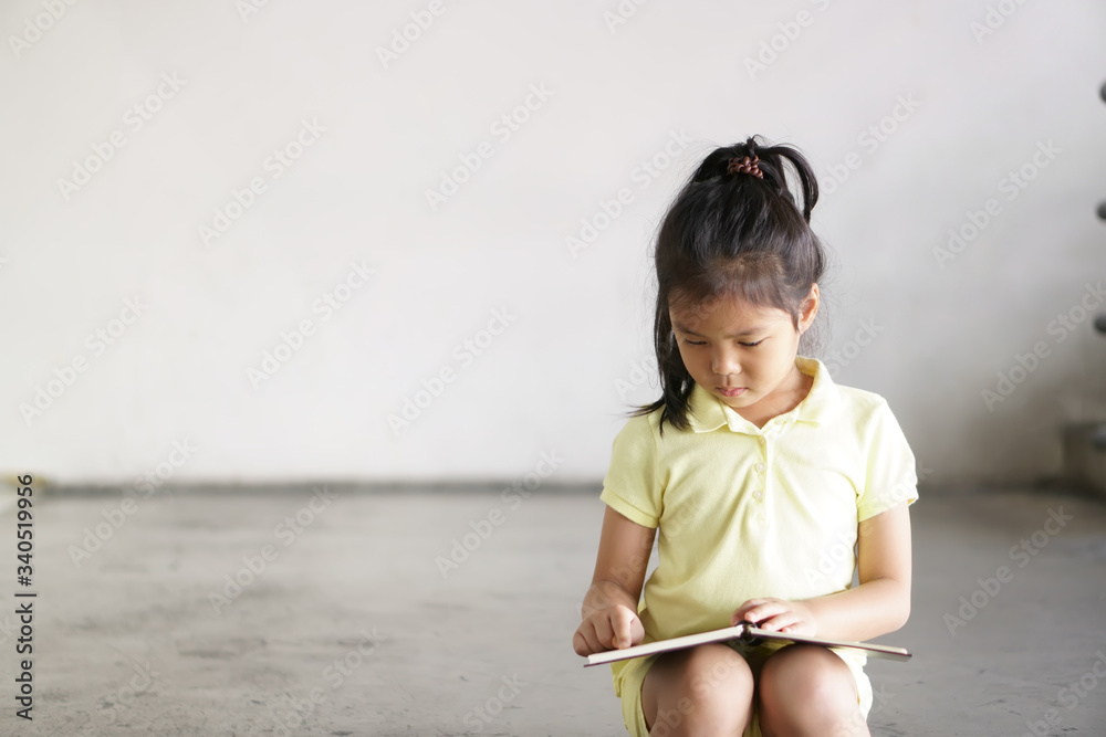asian child cute or kid girl happy reading story book or student enjoy ...