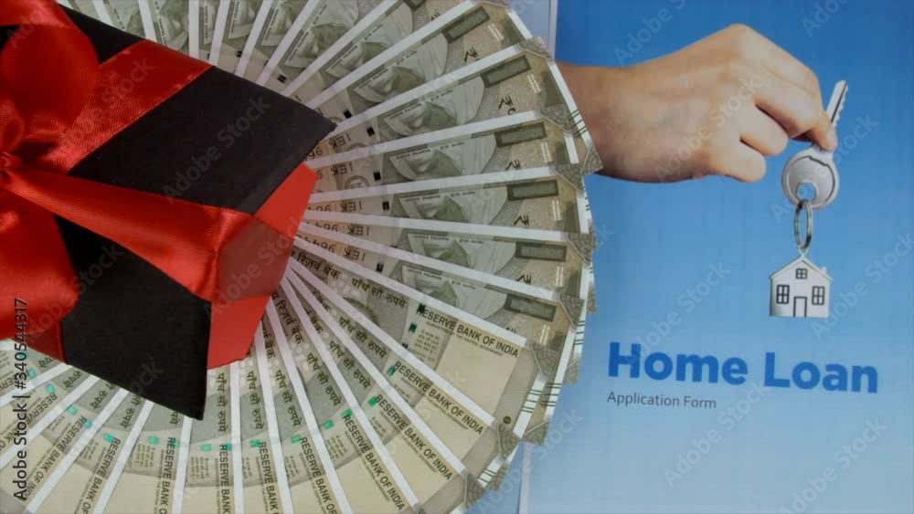 Closeup shot of a home loan application form with banknotes and a house ...