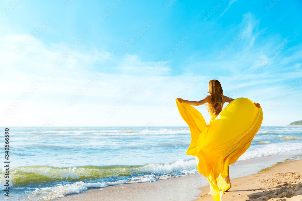 Woman on Sunny Sea Beach in Yellow Fluttering Dress, Fashion Model Back ...