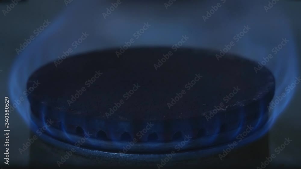 A kitchen burner from a match is turned on. The top burner caught fire ...