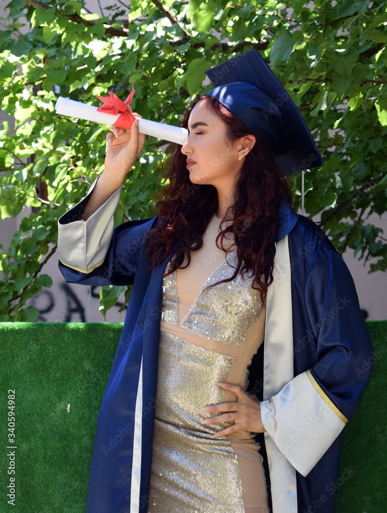 College graduate in graduation clothes with diplomas in their hands ...