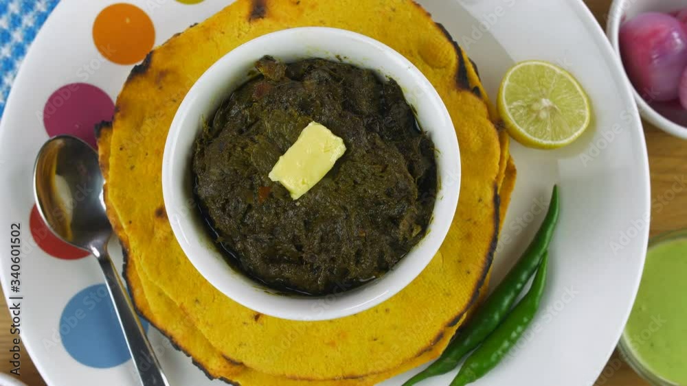 Traditional Punjabi cuisine Makki Ki Roti and Saag served in ceramic ...