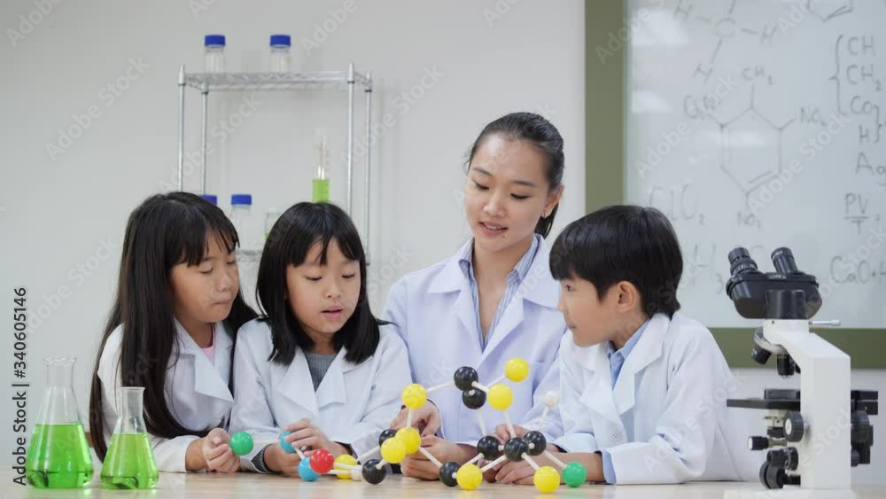 Asian teacher women or scientist female teaching children in classroom ...