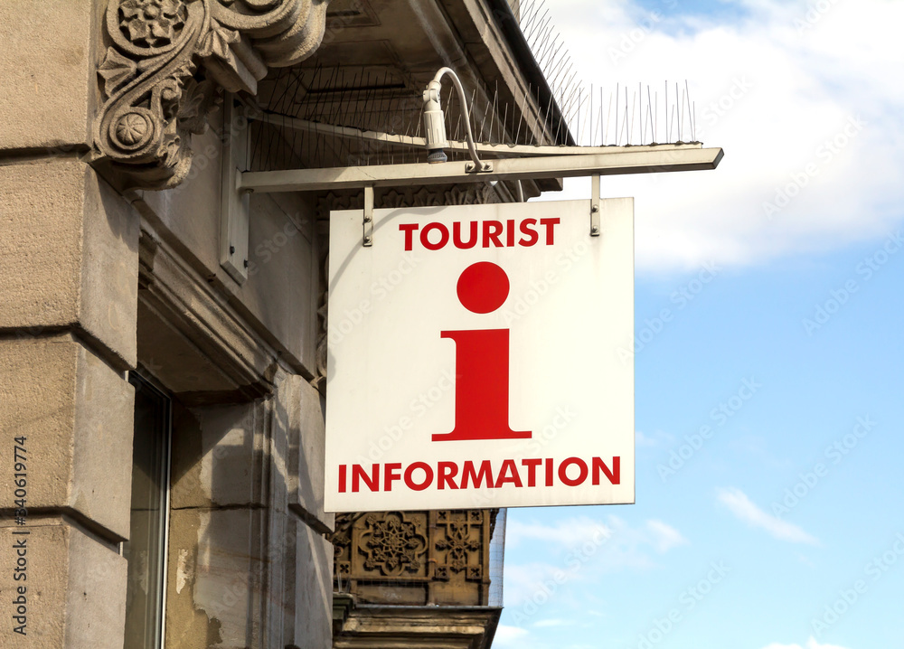 sign indicating tourist office with symbol for information is also ...