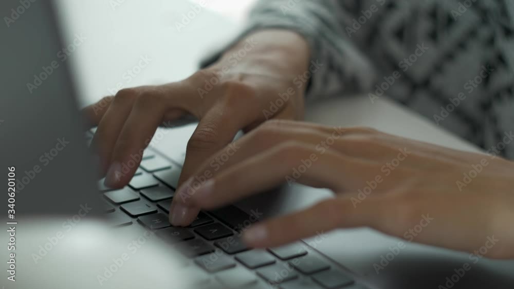 Young caucasian woman's hands typing on the keyboard of laptop, real ...