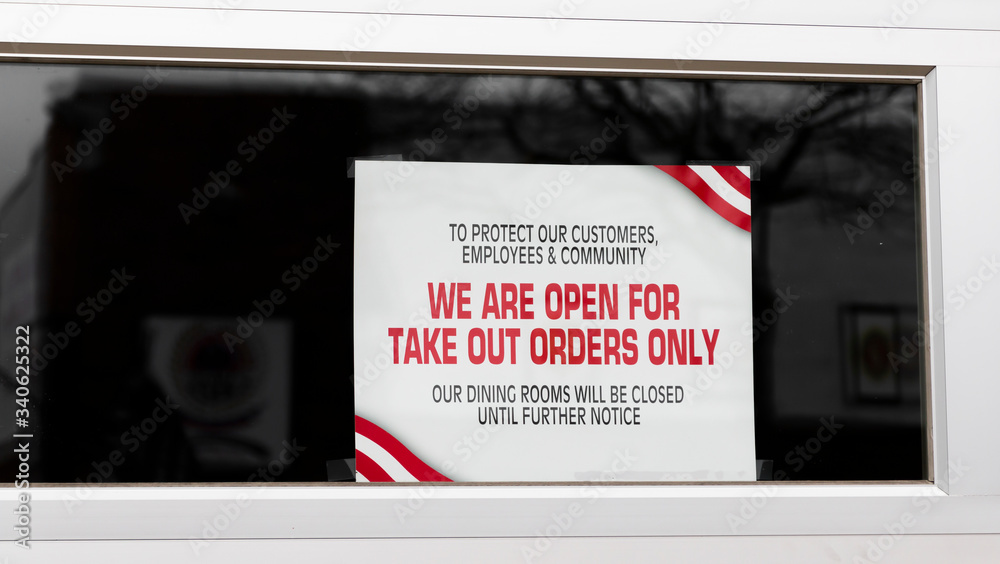 Open for take out orders only sign in window of restaurant Stock Photo ...