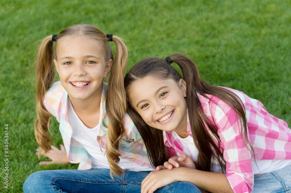Girls rule, enjoy. Happy girls sit on green grass. Beauty look of ...