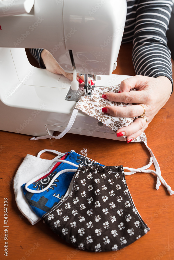 Young woman making home made breathing mask, corona virus protection ...