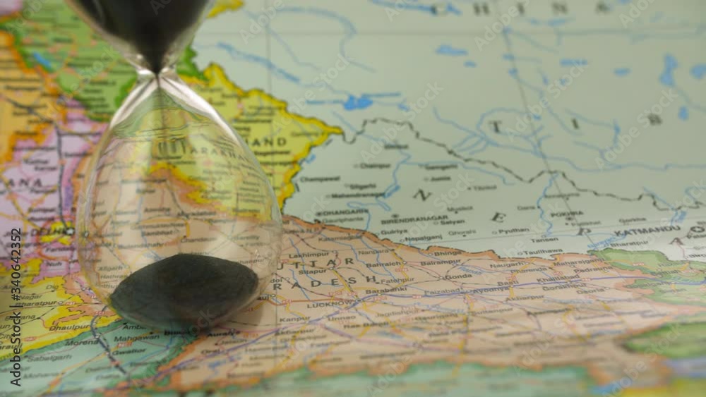 Pan shot of a colorful and detailed map of India with a compass and a ...