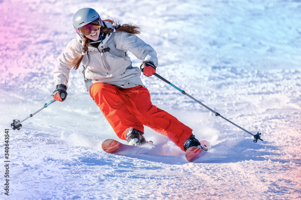 Girl On the Ski. a skier in a bright suit and outfit with long pigtails ...
