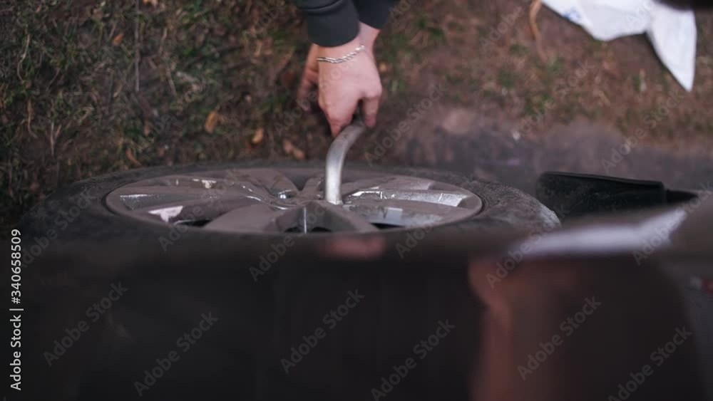 Change the wheel of the car. Man's hands are changing the wheel of the ...