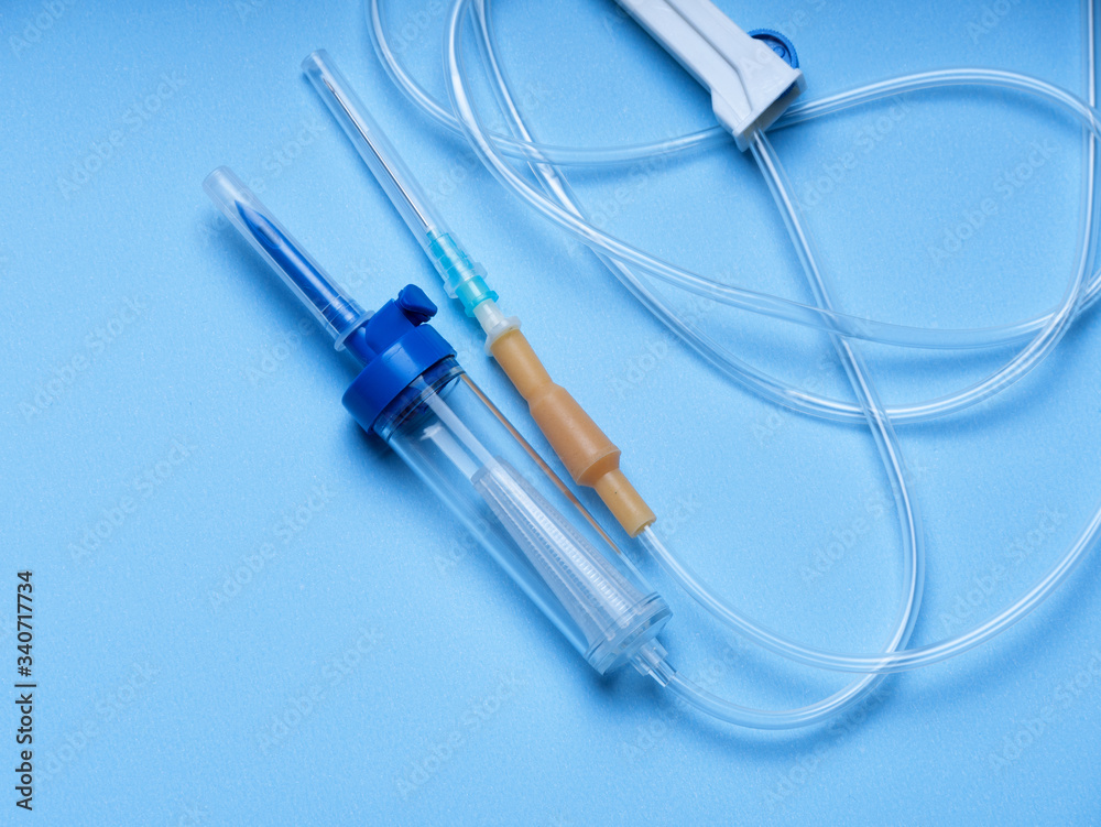 glass medicine bottle with syringe injection, dropper system on blue ...