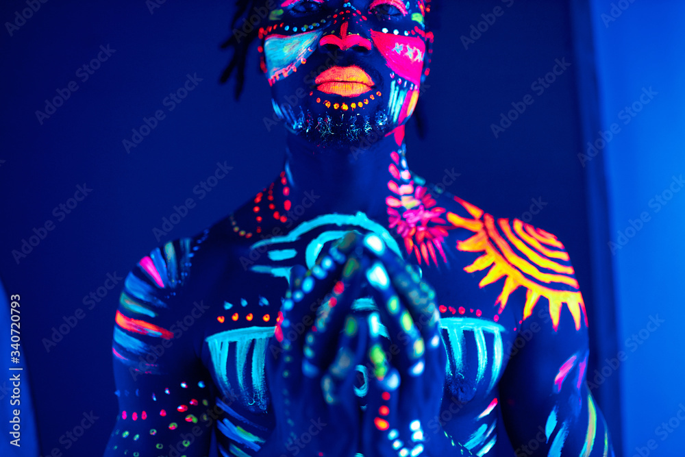 african male fashion model having fluorescent make-up and body art ...