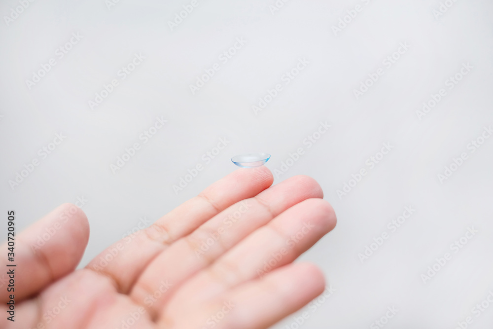 Lens on the finger. The transparent lens is on your hand. lens on a ...