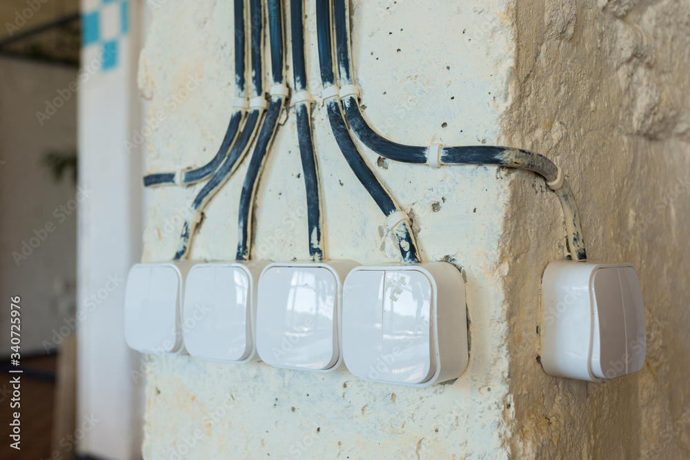 external wiring of black wires in a column for light switches in an ...