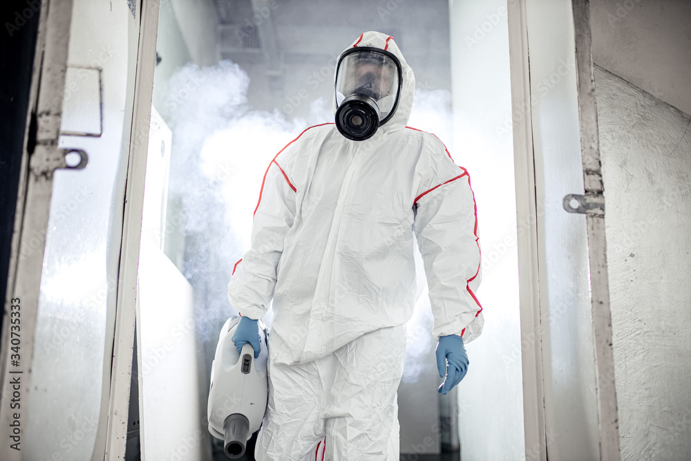 professional disinfector in an NBC personal protective equipment ppe ...