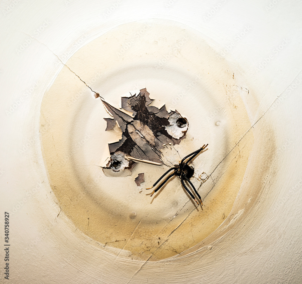 Bad installation of the light under ceiling Stock Photo | Adobe Stock