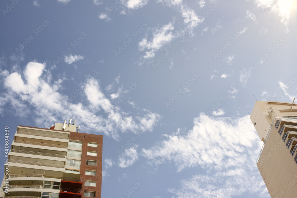 Top of residence buildings with sky with clouds and solar backlight ...