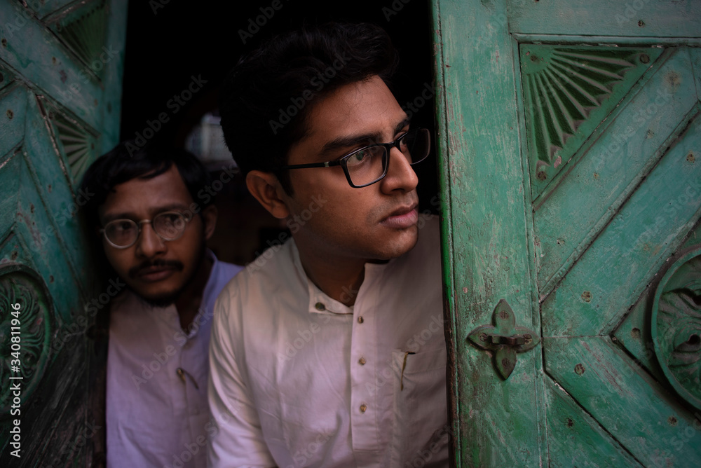 Young Indian Bengali detective and his colleague with traditional wear ...