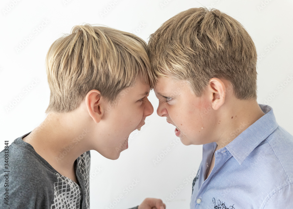 boys are fighting. bullying at school. the boy is attacking week boy ...