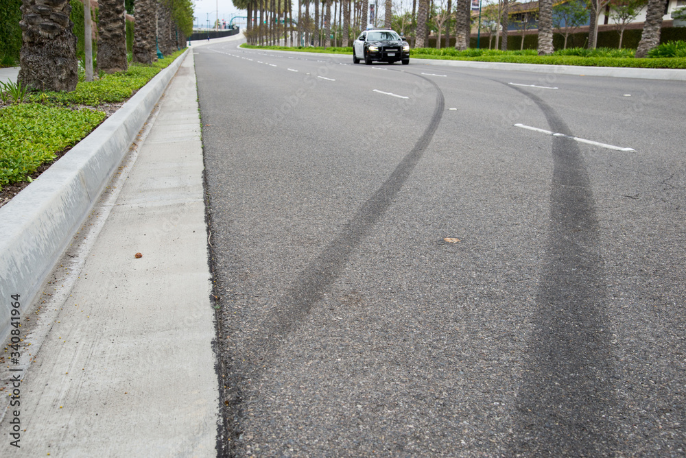 Left over skid marks from a street racing crash. (The police car was ...