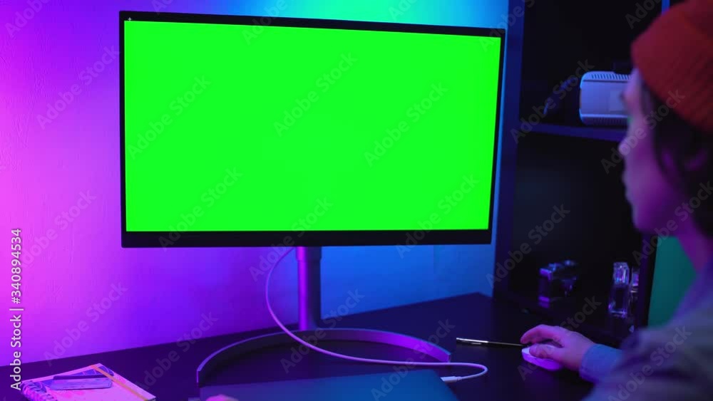 Man Works on His Personal Computer with Big Green Screen Mock Up ...