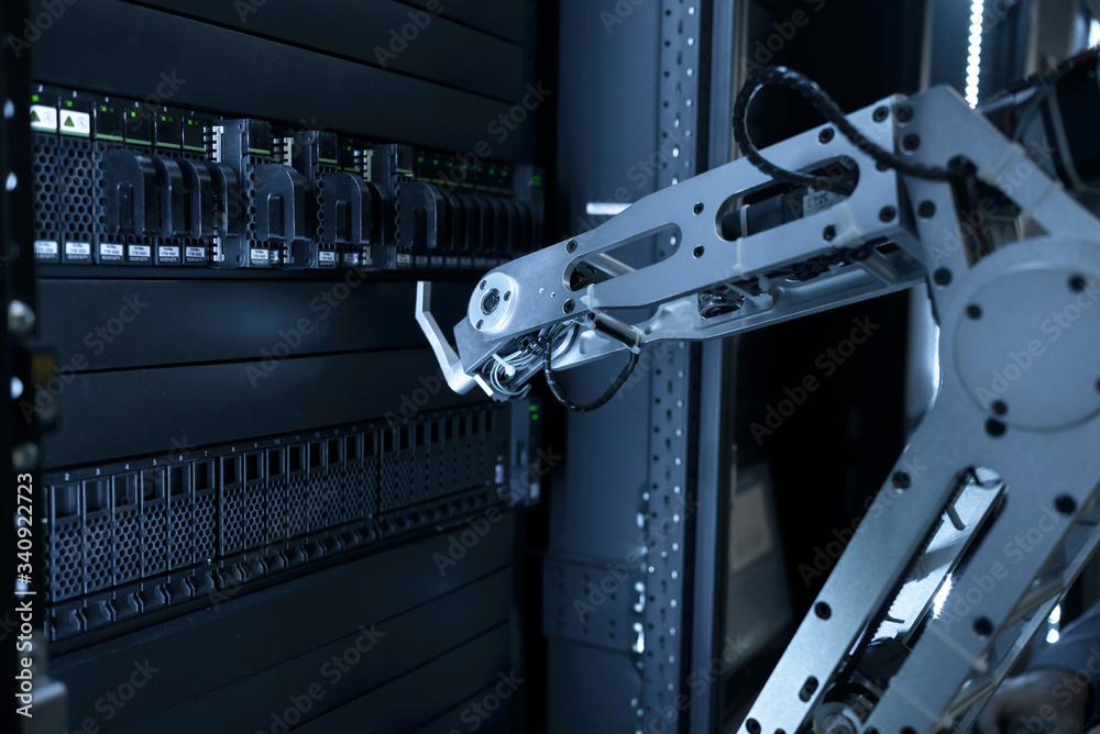 Robot arm is manually operating data center hardware Stock Photo ...