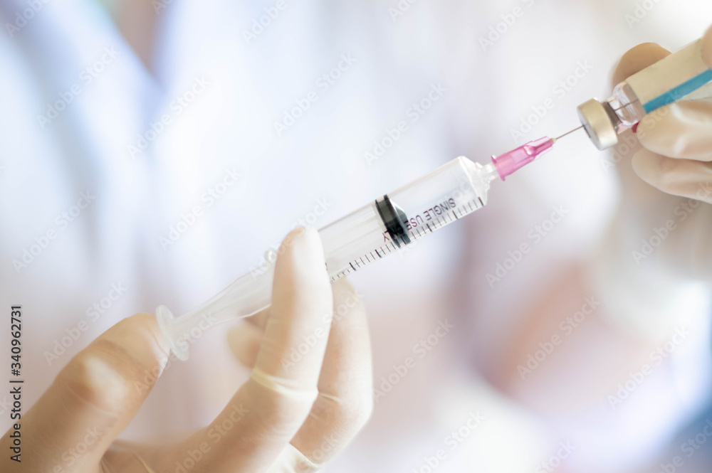 Syringe medical injection in hand holding with medicine dose ...