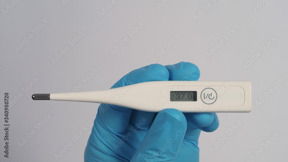 Digital thermometer white color in doctor hands wearing hospital ...