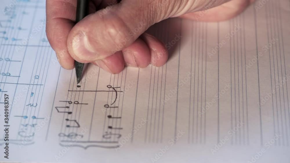 hand of a composer writing in old style method, musician writing a ...
